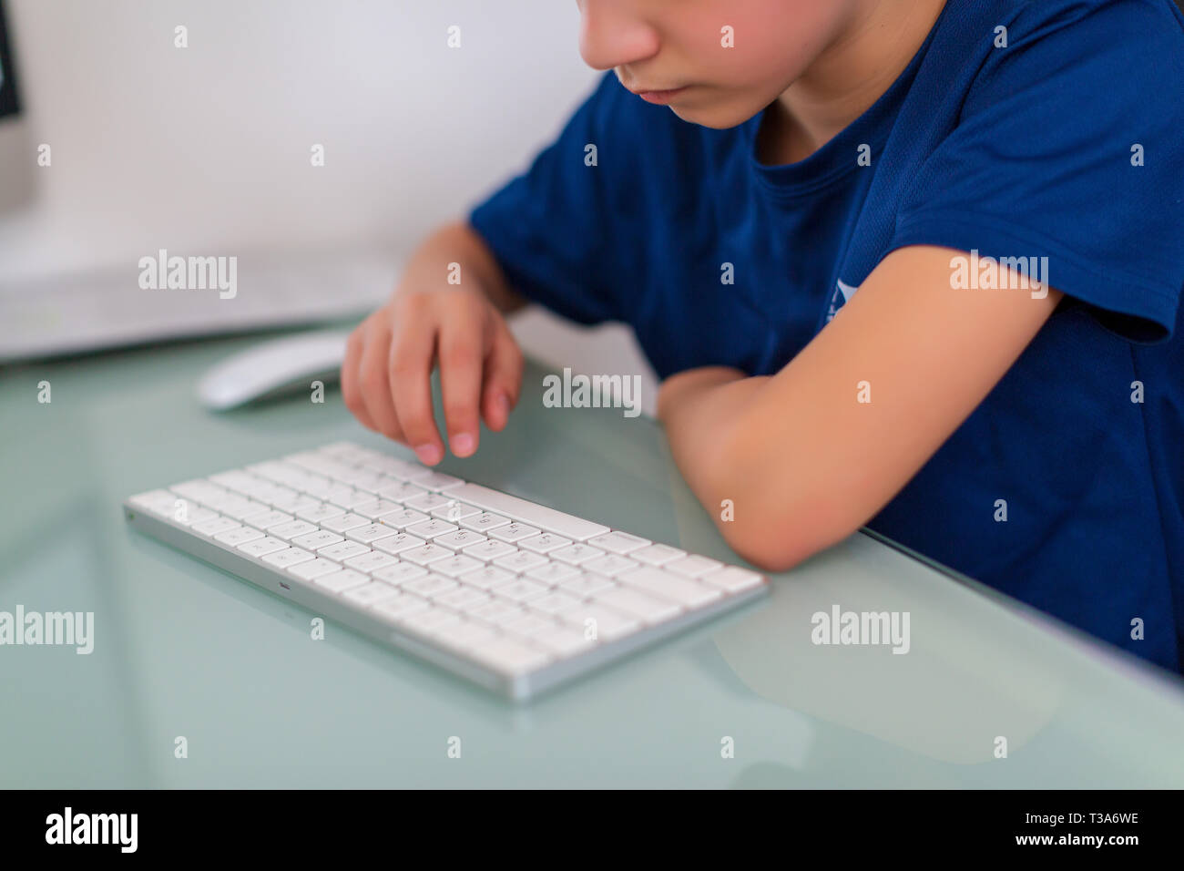 Little boy using computer in the living room at home Stock Photo - Alamy