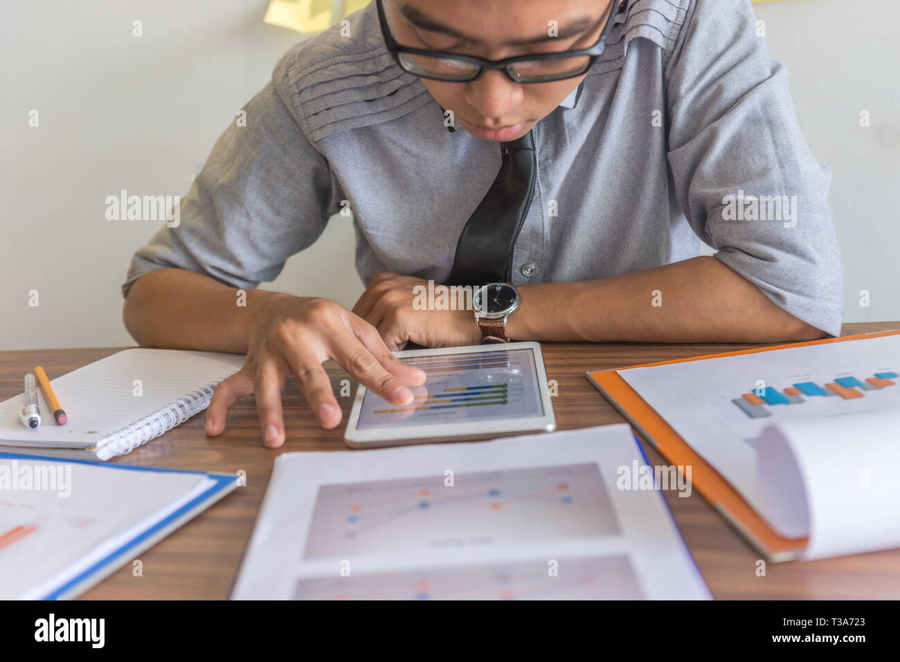 Office man reading data on the tablet Stock Photo - Alamy