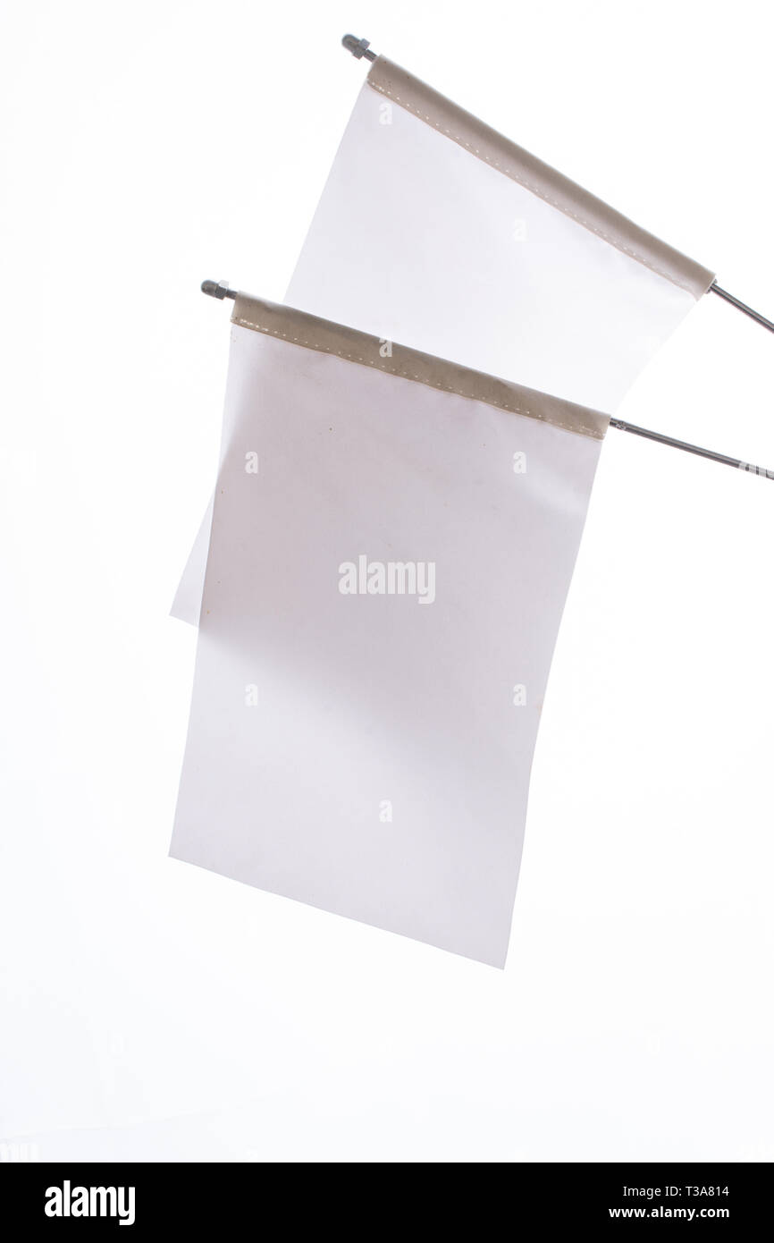 Two white flags on a white background in the display Stock Photo - Alamy