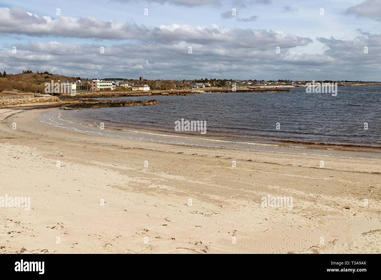 Beach with sand and buildings in Galway Bay, Spiddal, Galway, Ireland ...