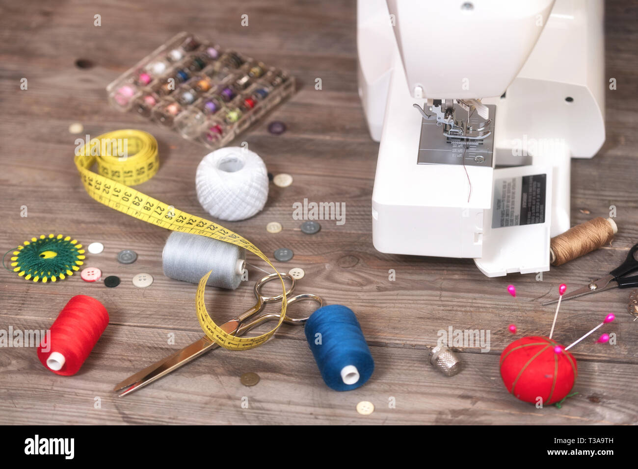 Seamstress or tailor background with sewing tools, colorful threads ...