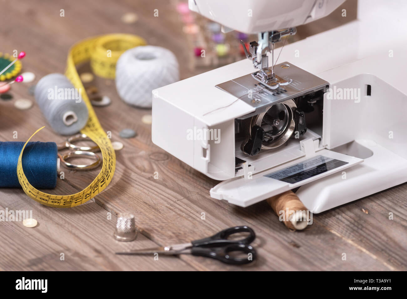 Seamstress or tailor background with sewing tools, colorful threads ...