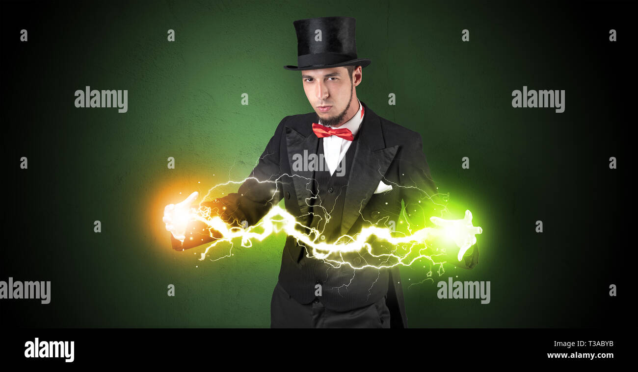 Magician sparkling super power between his two hands Stock Photo - Alamy