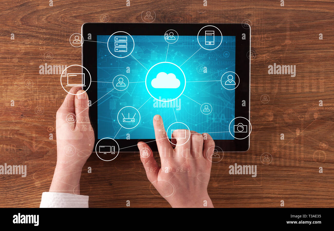 Hand touching tablet with cloud computing and online storage concept ...