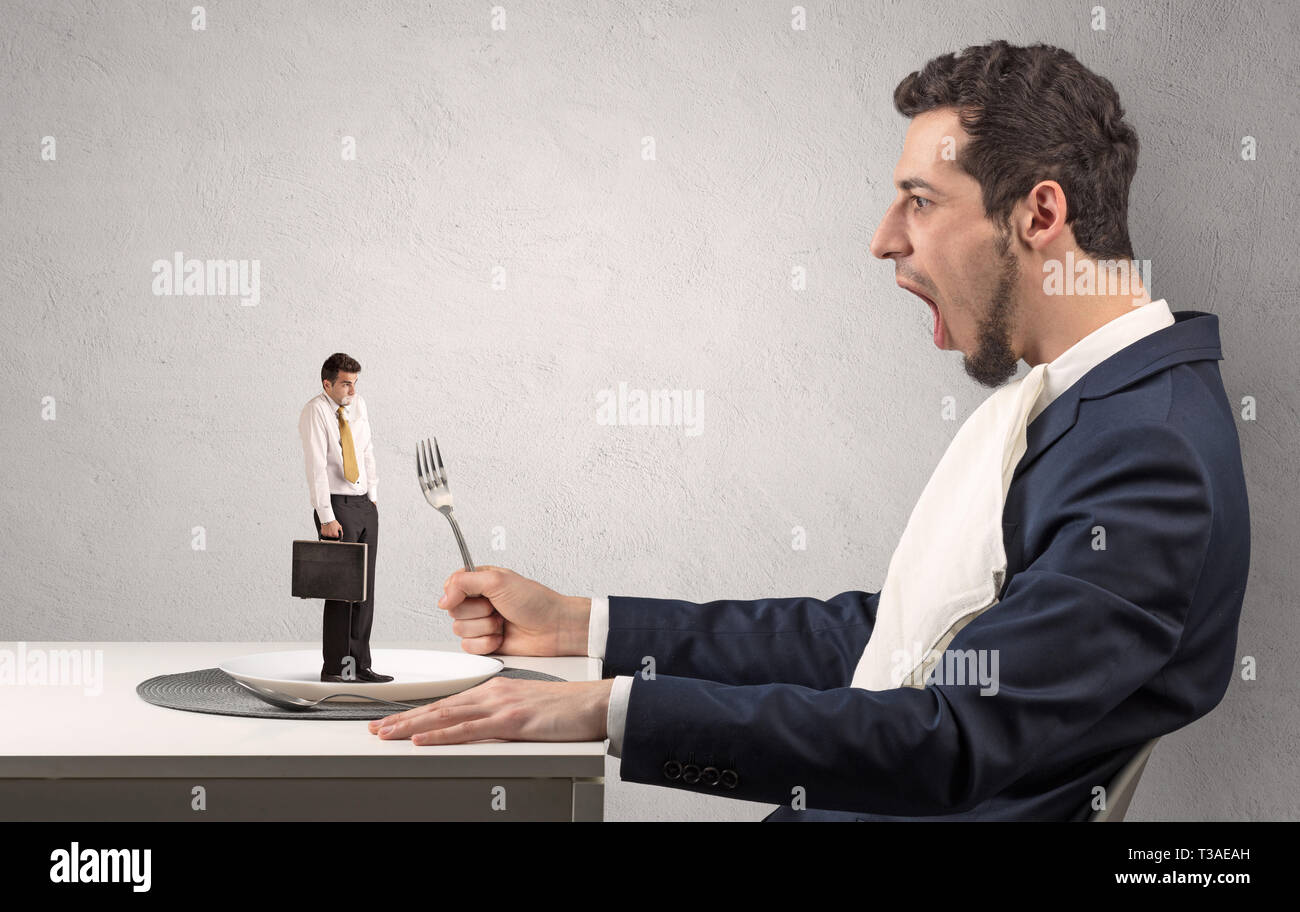 Tiny scared weak businessman almost devoured by great power Stock Photo ...