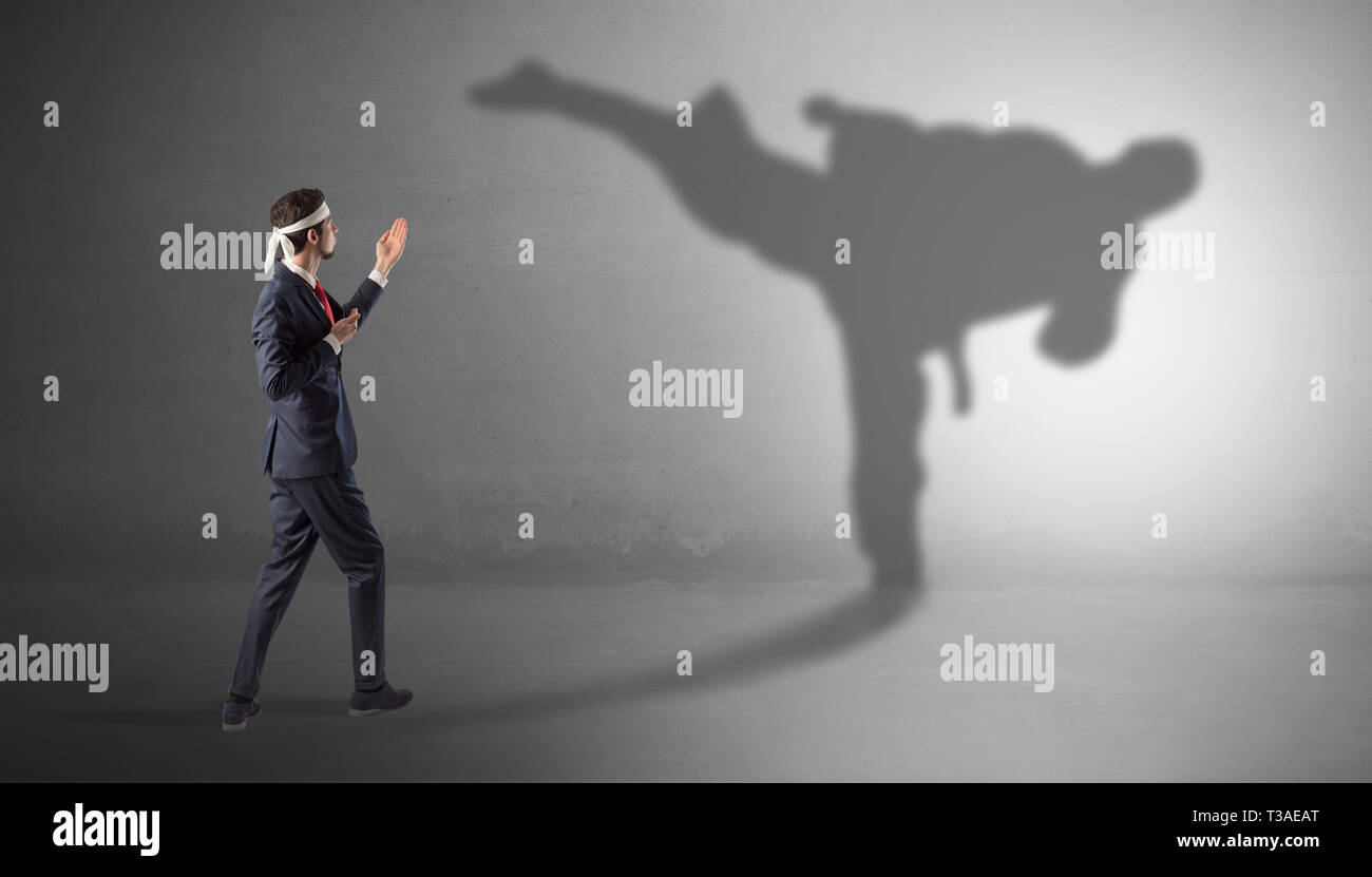 Businessman fighting with his strong karate man shadow Stock Photo - Alamy