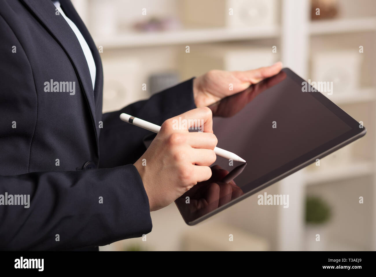Business woman below chest using tablet in a homey environment Stock ...