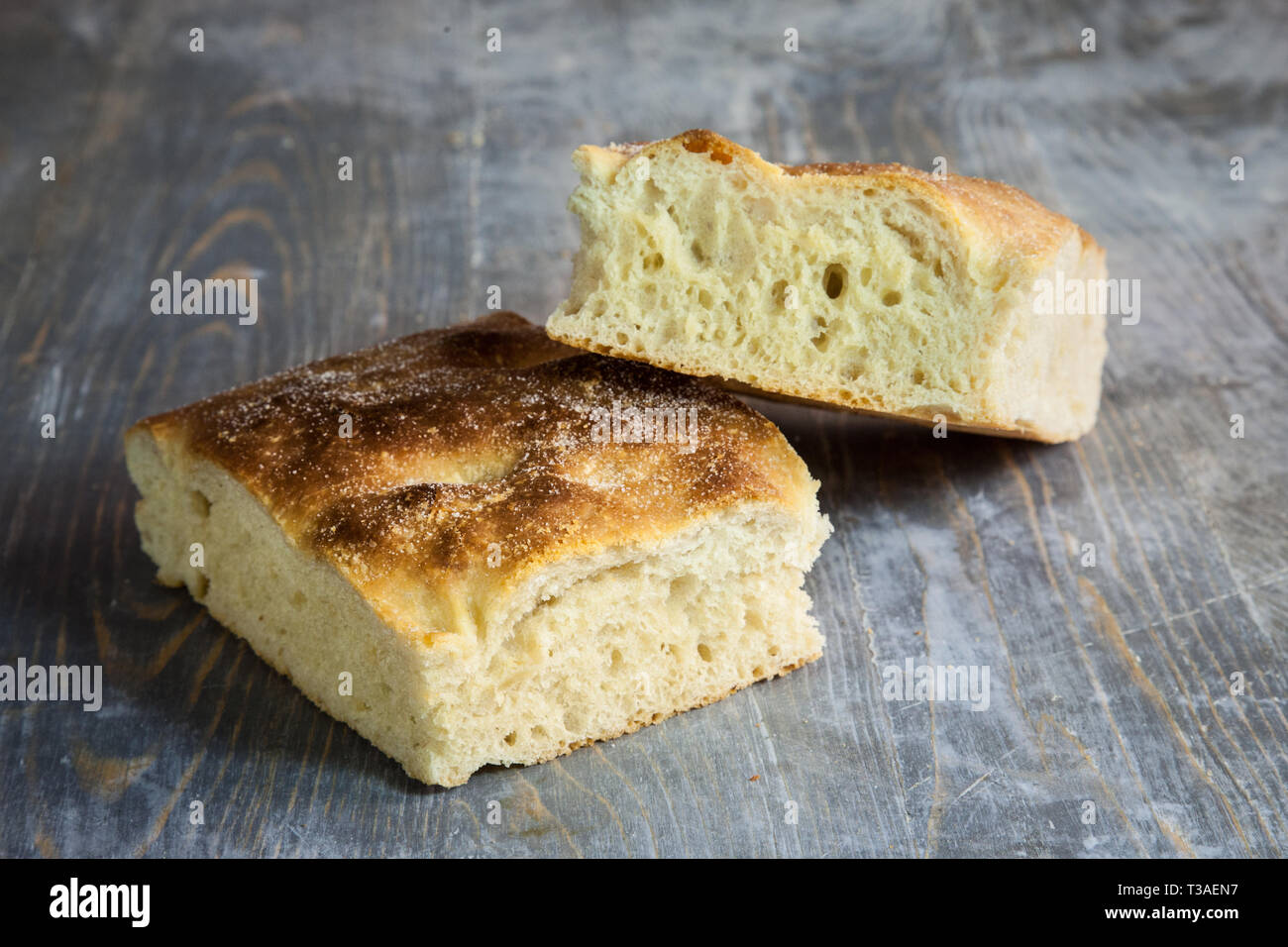 Italian bread of Focaccia Genovese type on a rustic wooden table ...