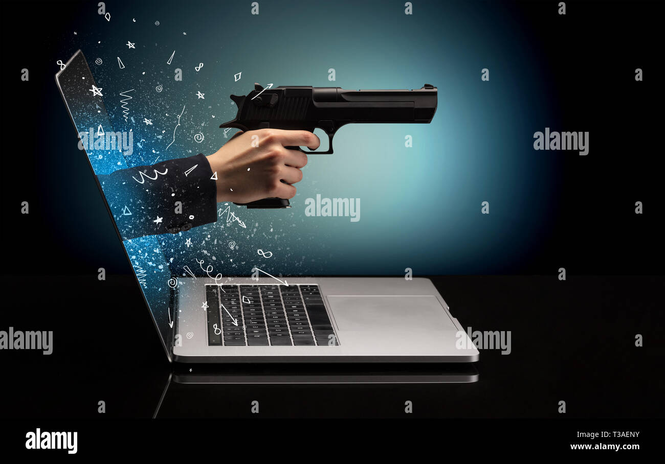 Hand with gun coming out of a laptop with sparkling effects Stock Photo ...