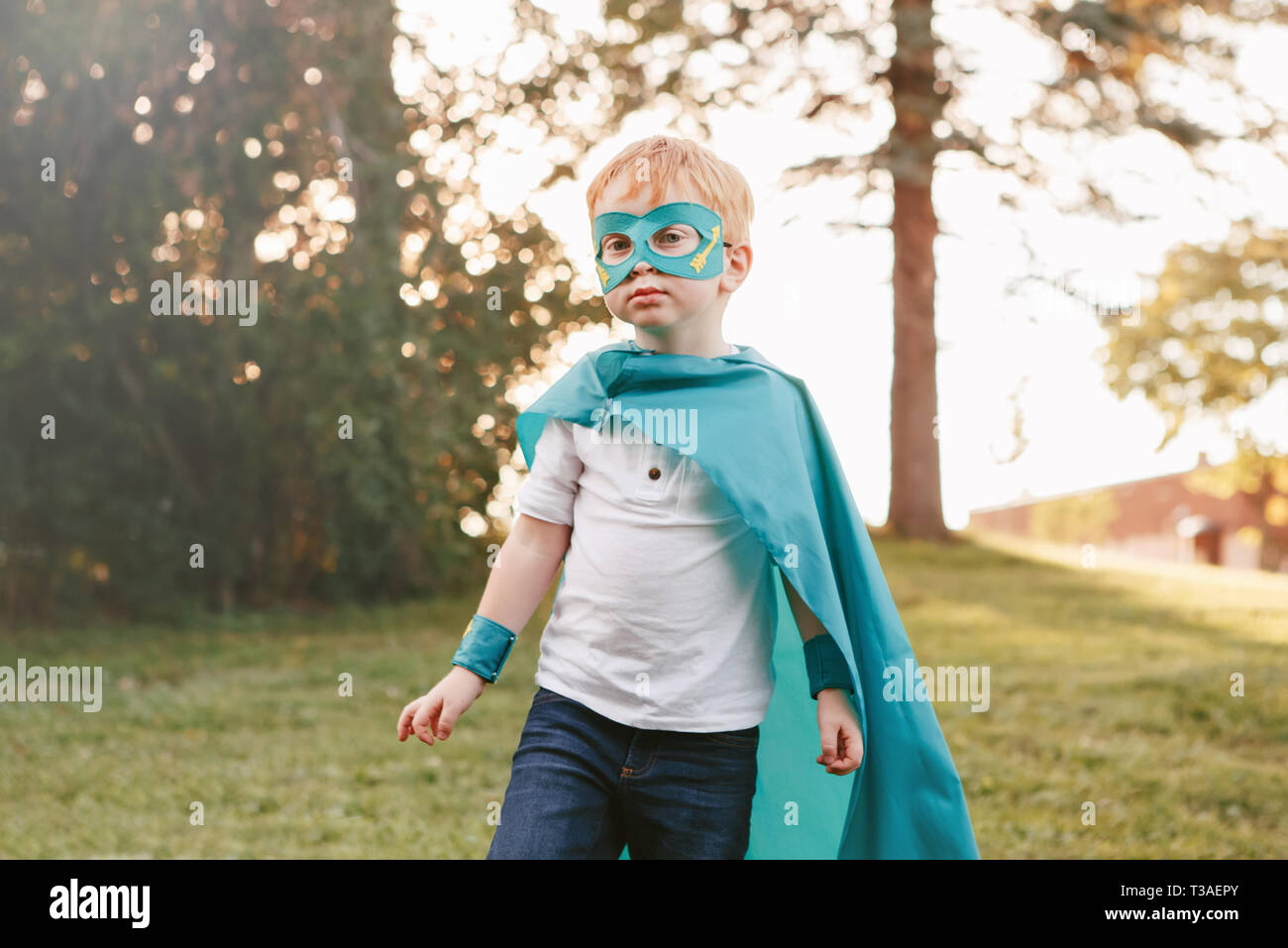 Cute adorable preschool Caucasian child playing superhero in green ...