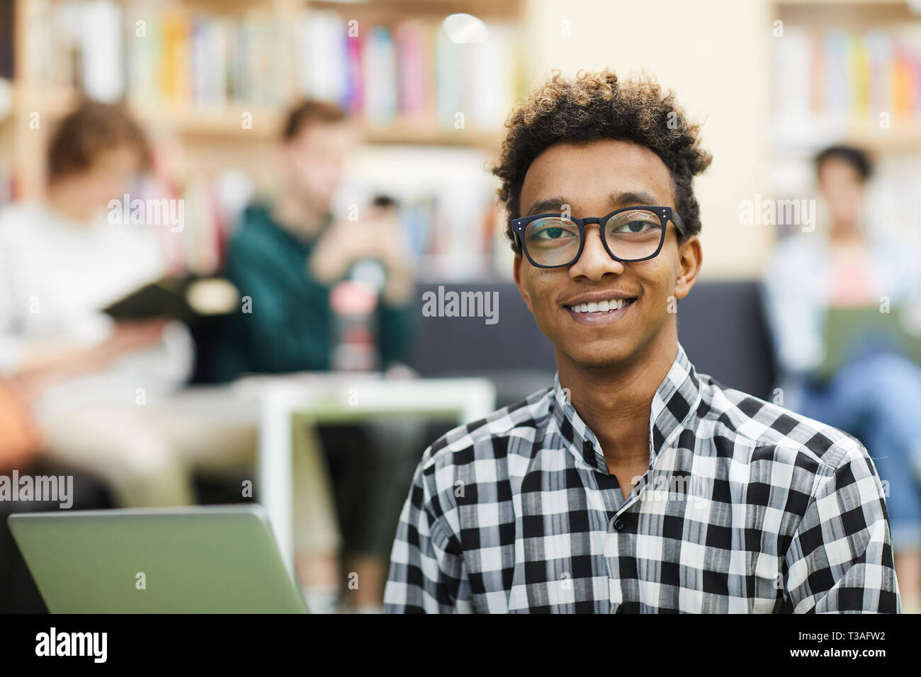 Smiling African student in book store Stock Photo - Alamy
