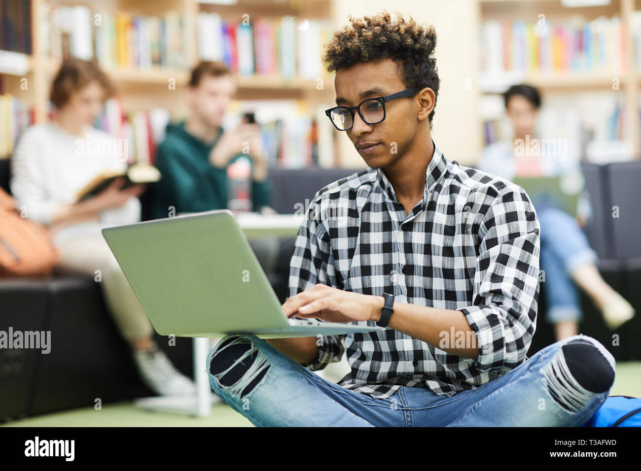 Black student boy preparing research Stock Photo - Alamy