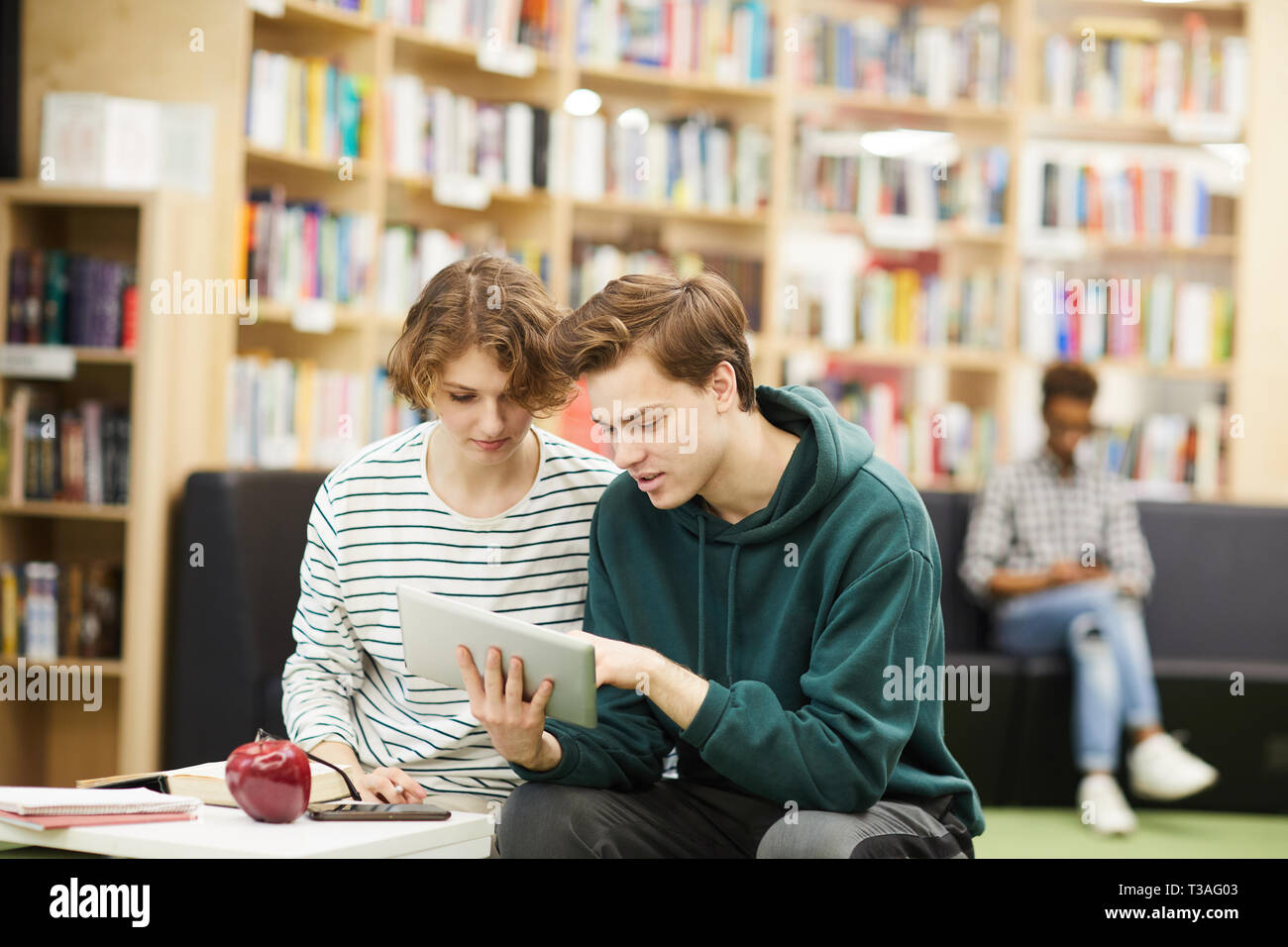 Students brainstorming about university project in library Stock Photo ...