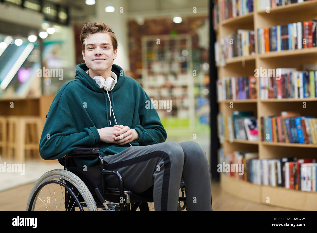 Content disabled student in library Stock Photo - Alamy