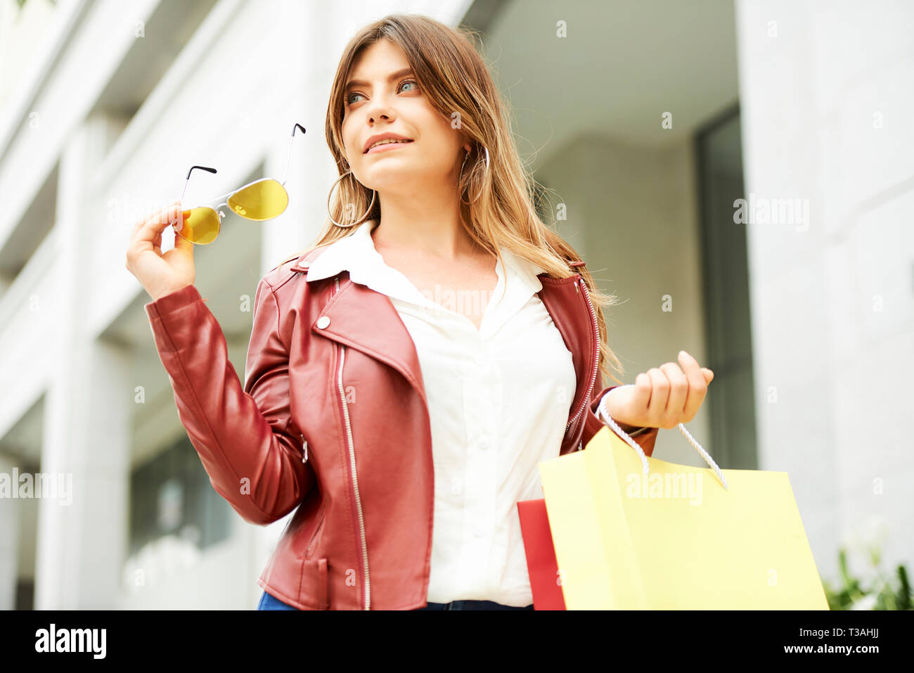 Woman taking off sunglasses Stock Photo - Alamy