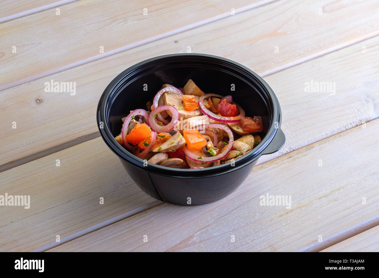 Lightly fried champignon with fresh onion rings and tomato. Snack for ...