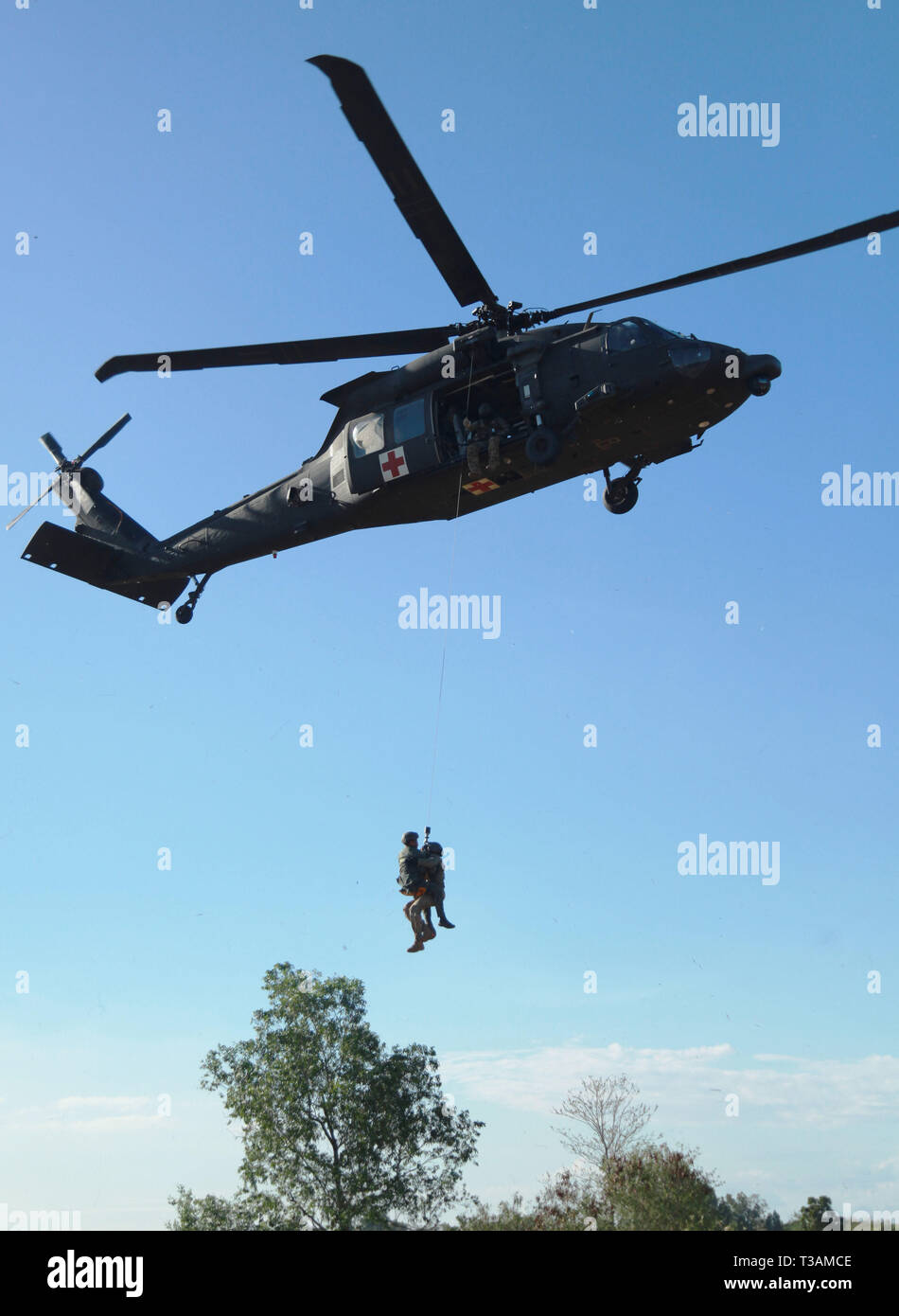 A UH-60 Blackhawk Helicopter hovers over the landing zone as a ...