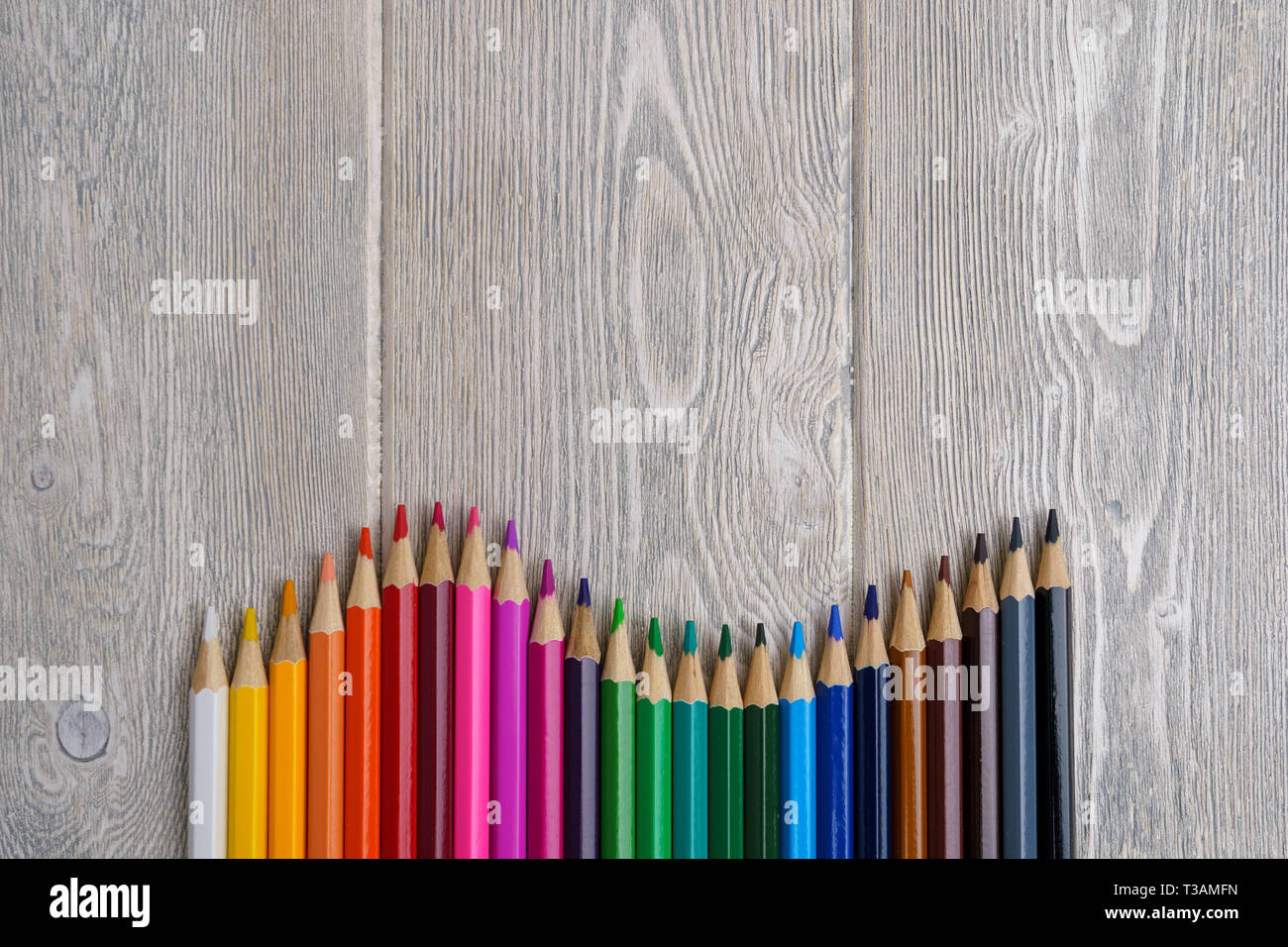 collection of rainbow spectrum color crayons on a white-grey vintage ...