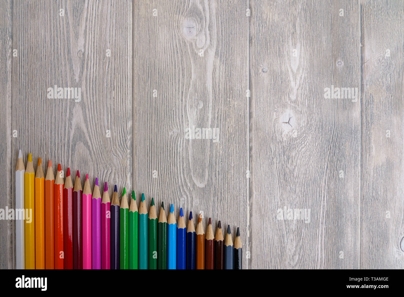 collection of rainbow spectrum color crayons on a white-grey vintage ...