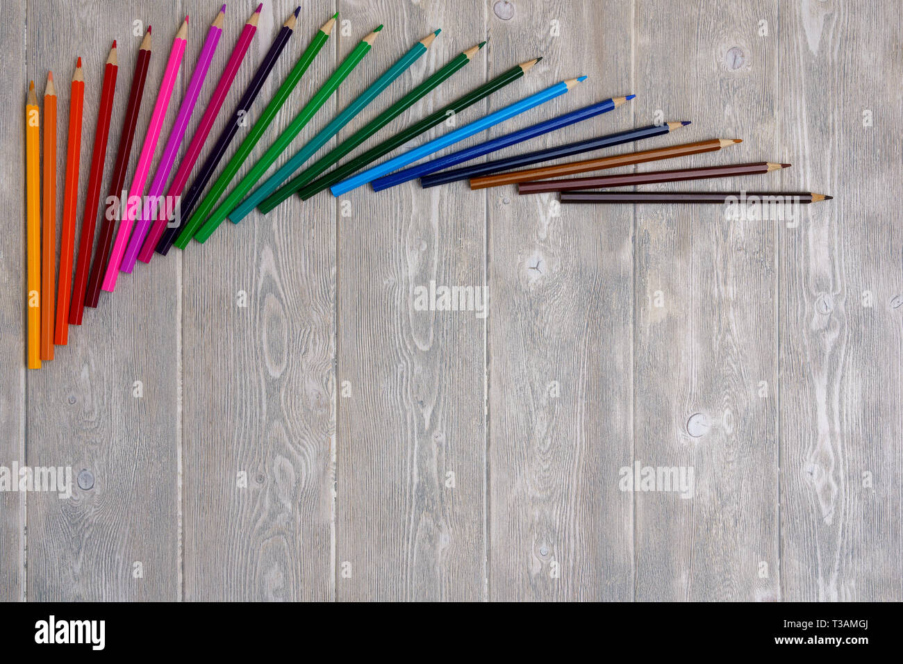 collection of rainbow spectrum color crayons on a white-grey vintage ...