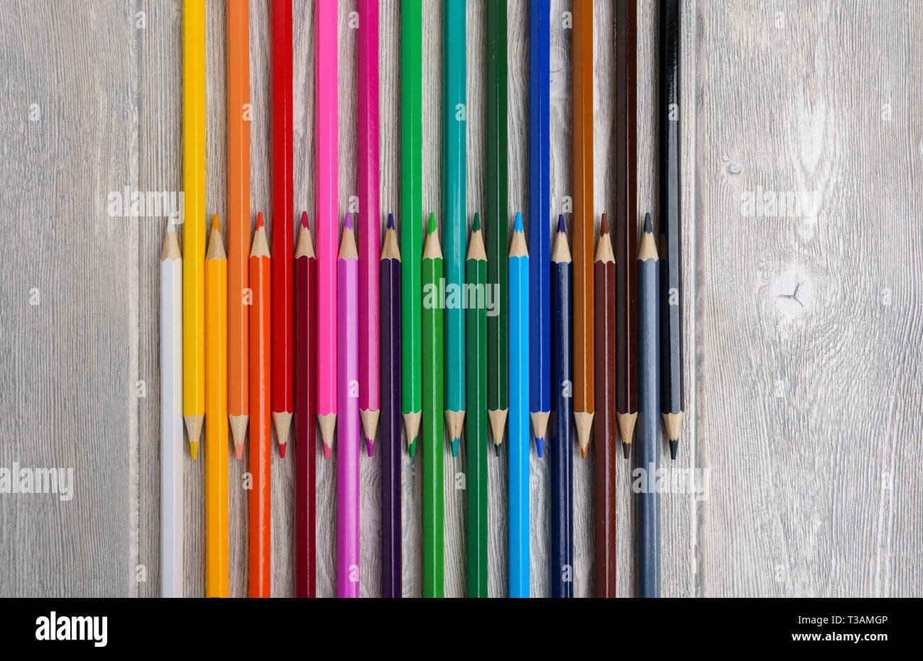 collection of rainbow spectrum color crayons on a white-grey vintage ...