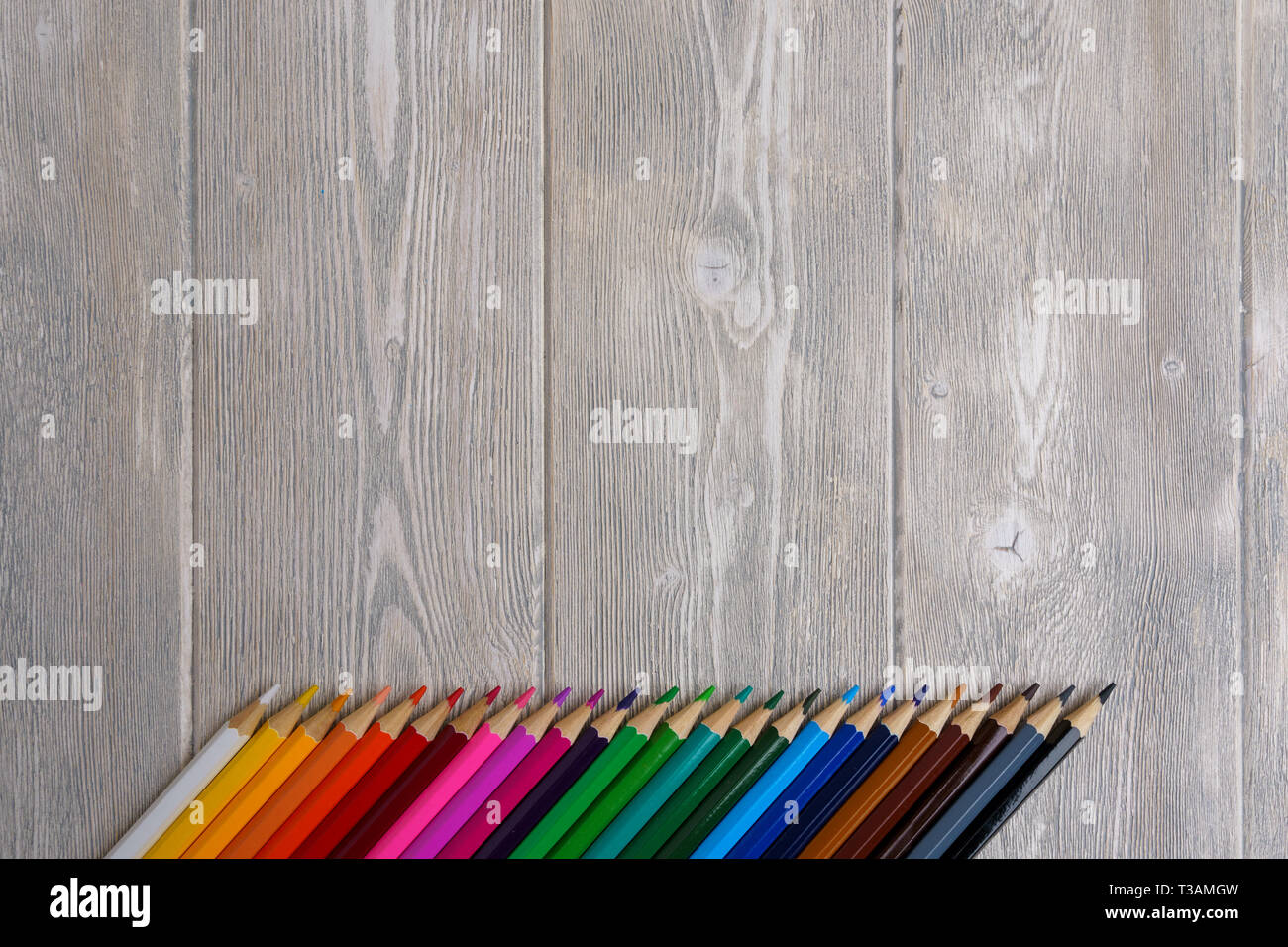 collection of rainbow spectrum color crayons on a white-grey vintage ...