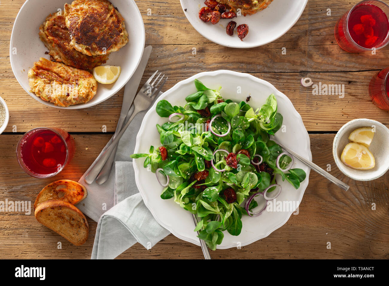 Healthy food concept. Vegetarian dinner table with green salad and ...