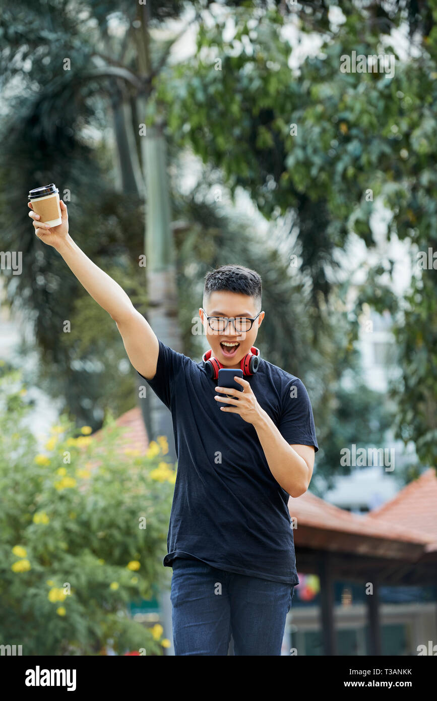 Asian student walking reading hi-res stock photography and images - Alamy