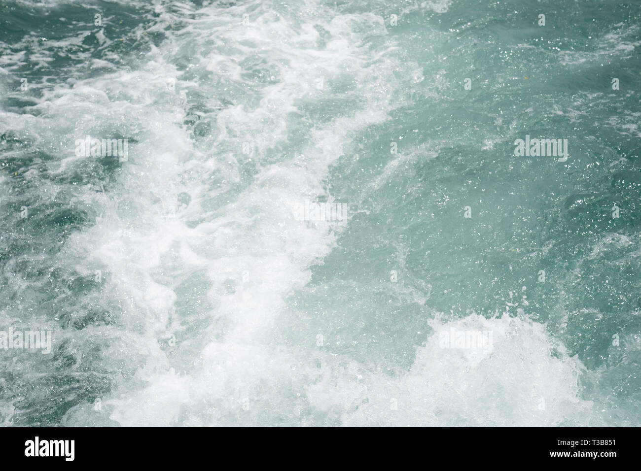 Close up Bubble wave Turquoise color from the bottom of the ship rowing ...