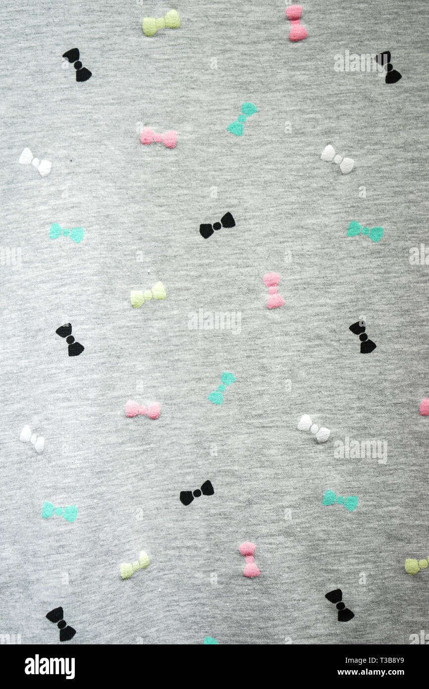 close up bow texture on the light gray textile, with pastel colour ...