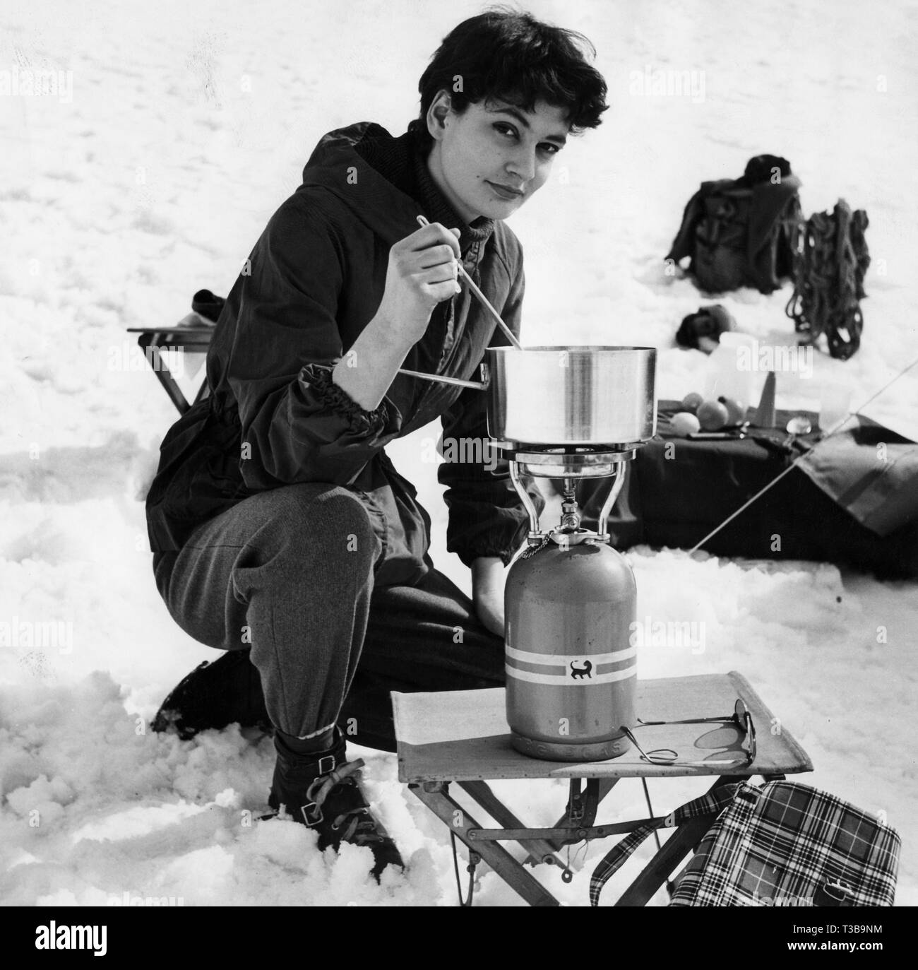 winter camping, cooking with gas cylinder, 1957 Stock Photo - Alamy