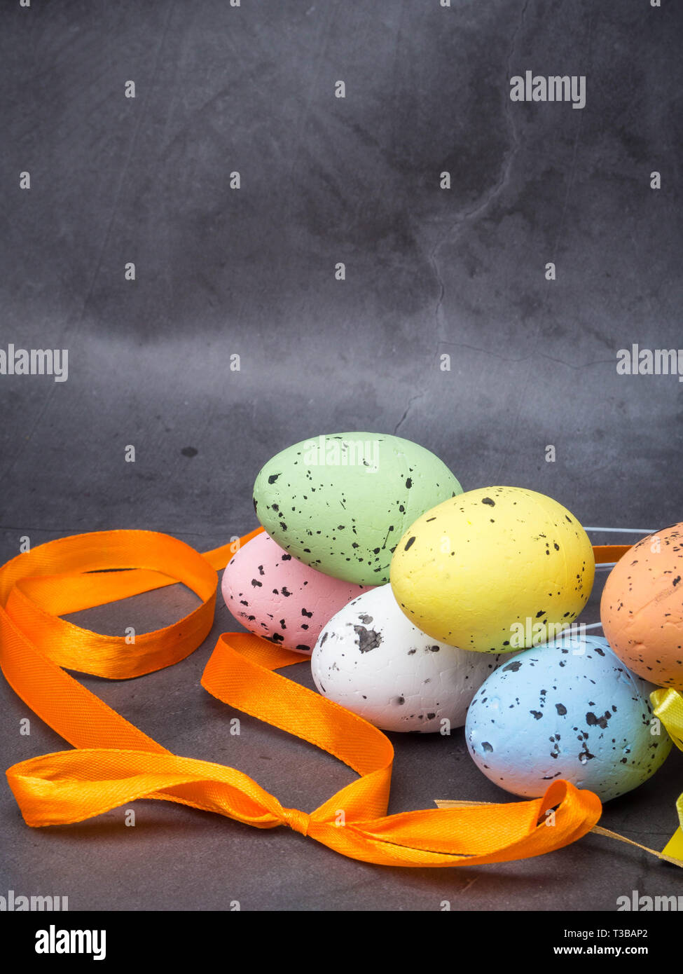 Easter composition with colorful eggs on grey concrete background ...