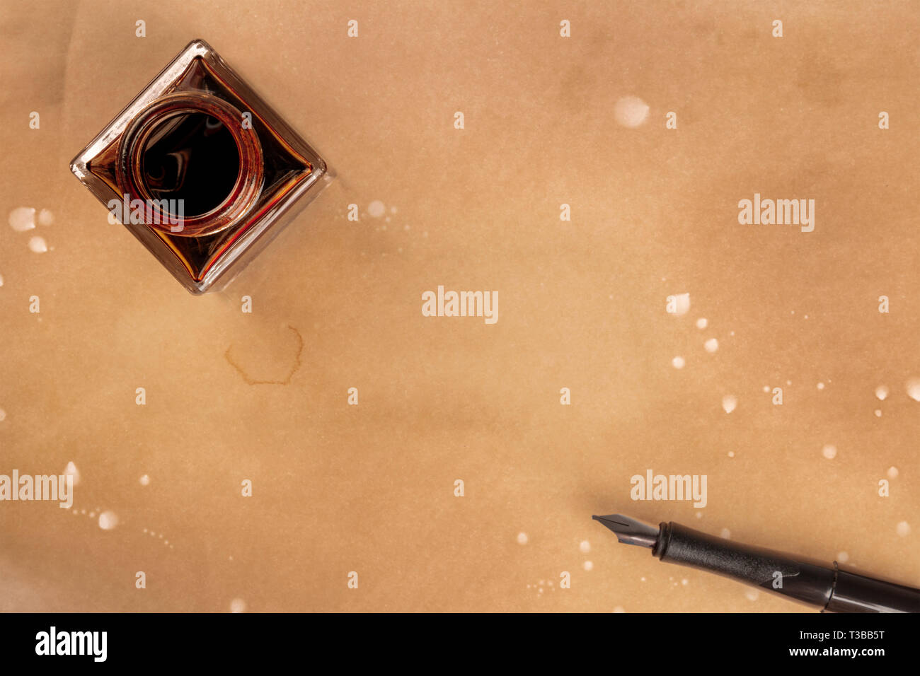 A vintage background with an ink pen and an ink well, shot from the top ...