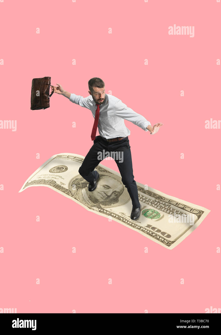 Business. Right way for investment. A man surfing on the dollar as on ...