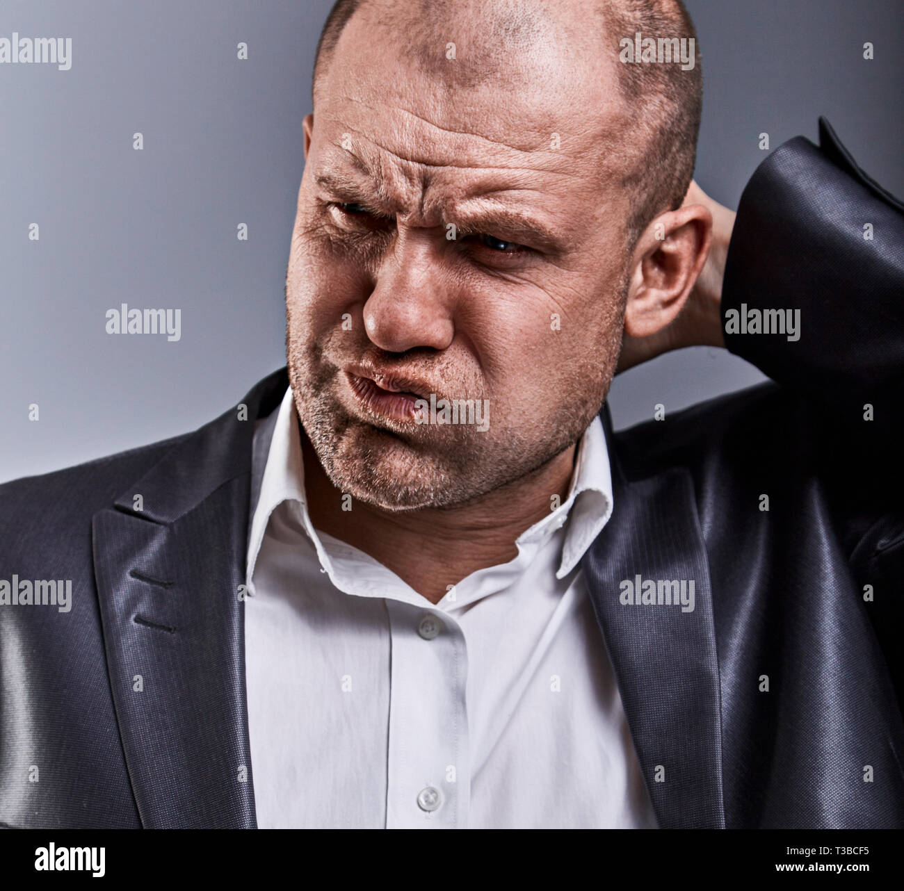Unhappy stressed bald angry business man to scratching the head with ...