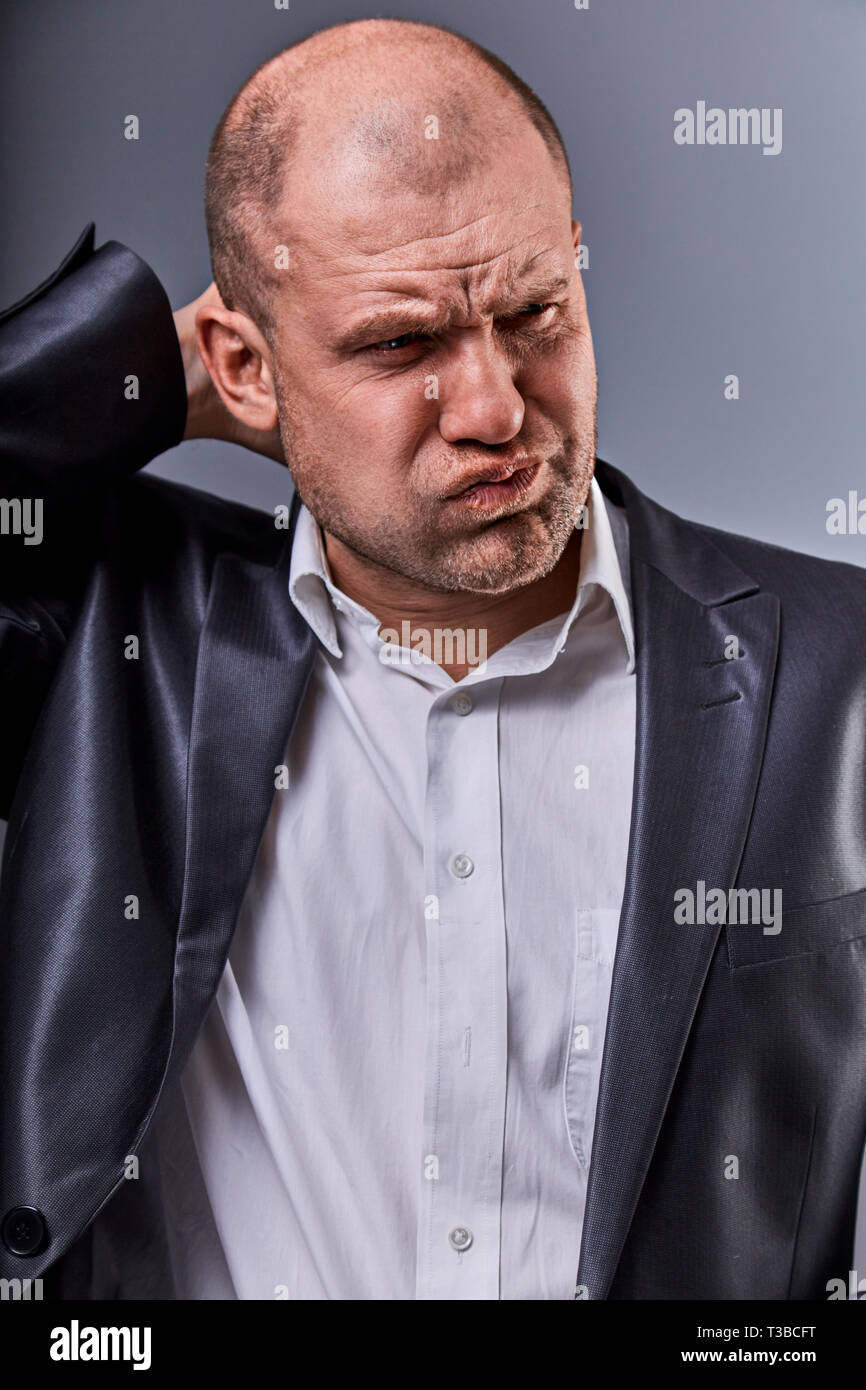 Unhappy stressed bald angry business man holding the head with very bad ...