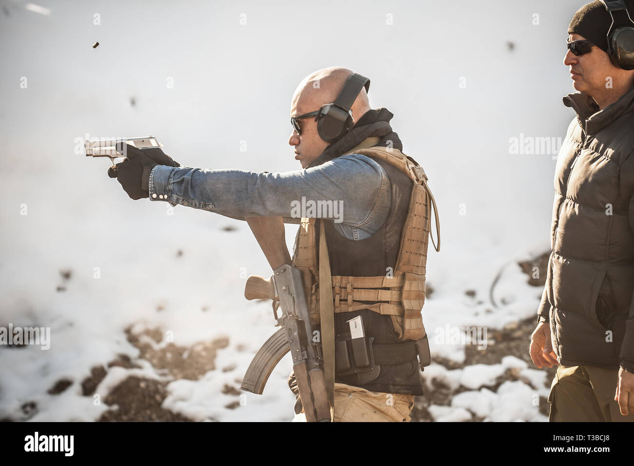 Army soldier training combat gun winter shooting on snow with his ...