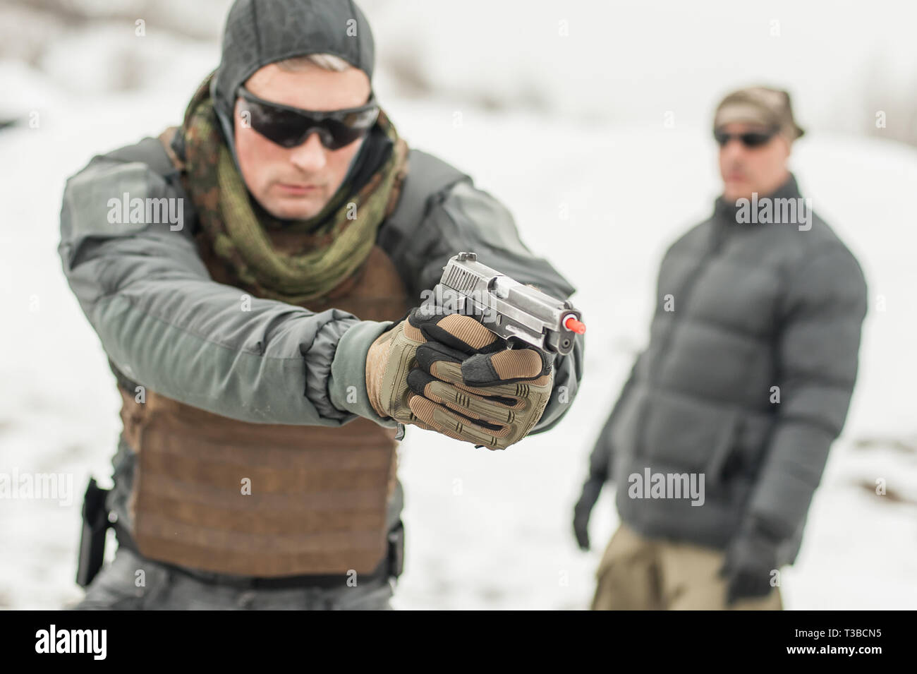 Army soldier training combat gun winter shooting on snow with his ...