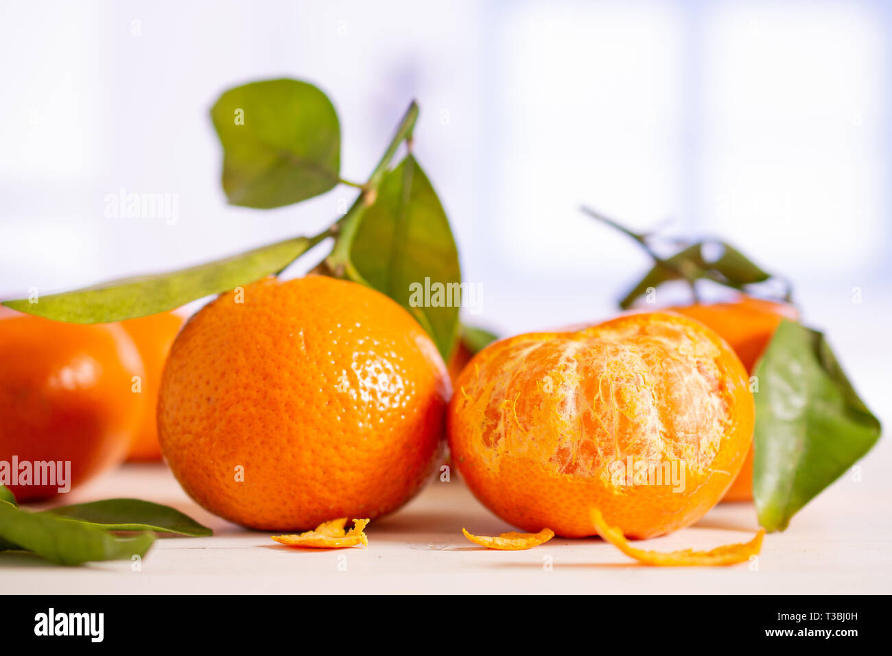 Group of five whole fresh orange mandarine with green leaves one fruit ...