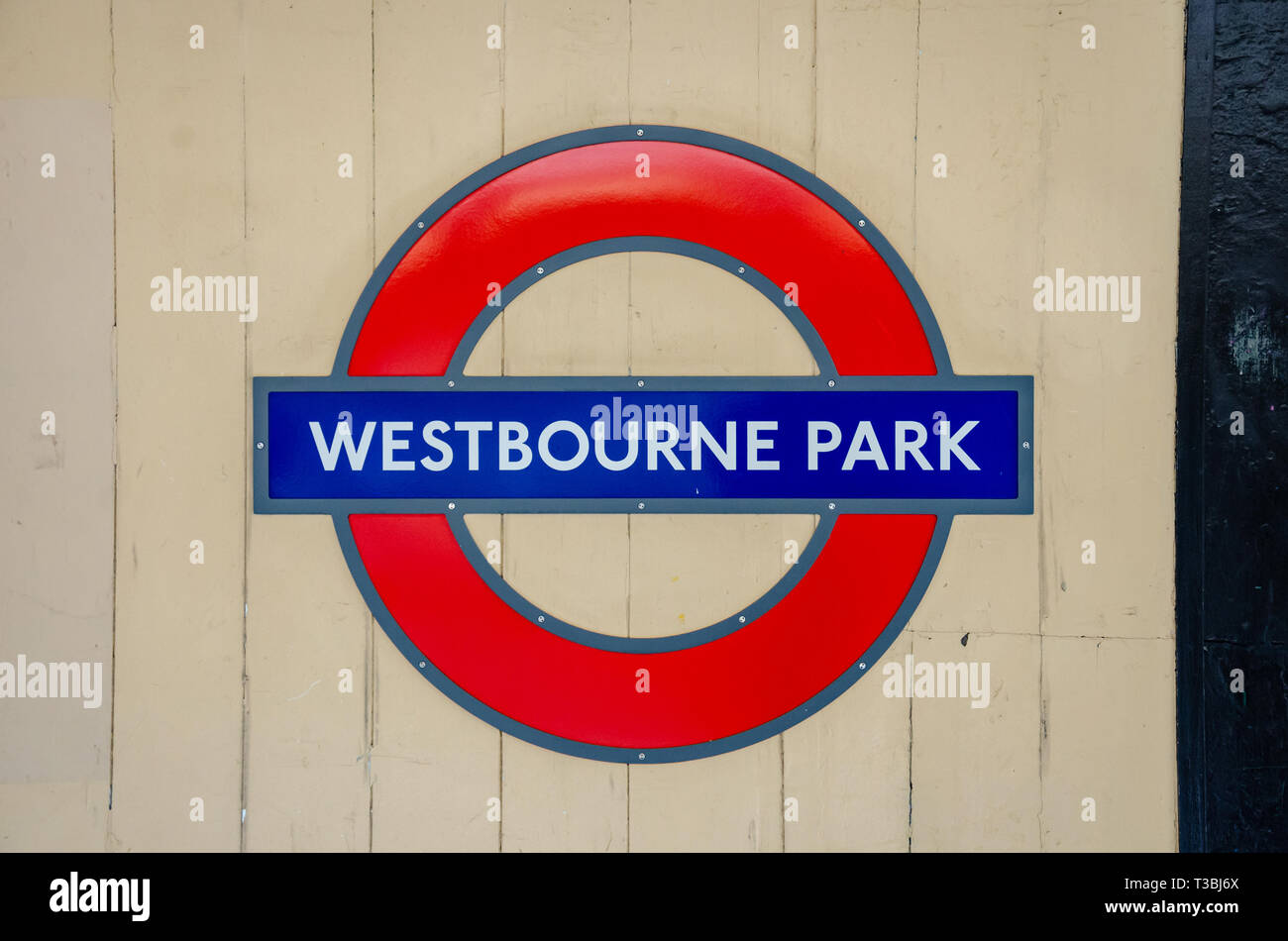 London Underground emblem bearing the name of the station on the wall ...