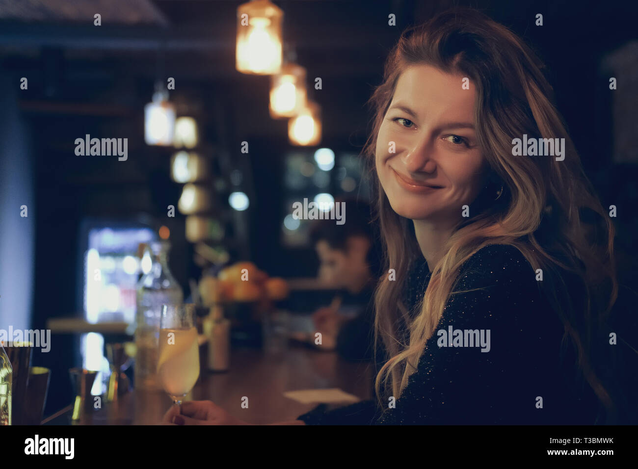 Pretty girl in bar spending time and having cocktail Stock Photo - Alamy