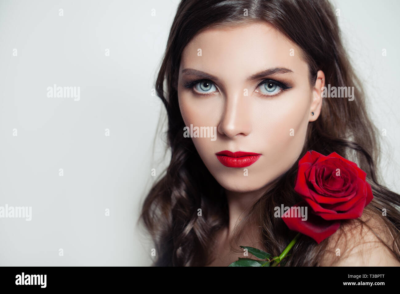 Cute model woman with red lips makeup holding red rose flower Stock ...