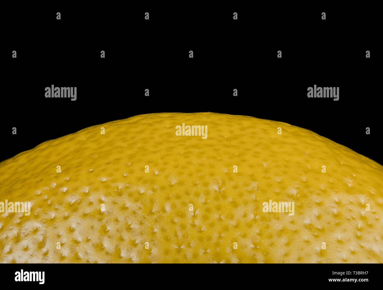 Macro image of a lemon skin against a black background Stock Photo - Alamy