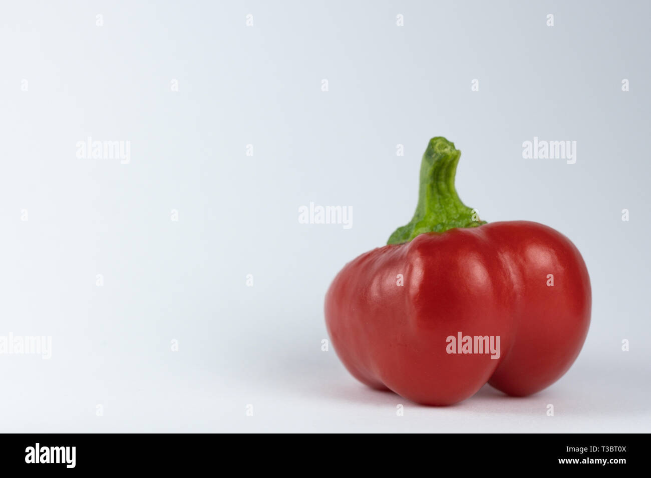 Closeup image of a red capsicum on a white background Stock Photo - Alamy