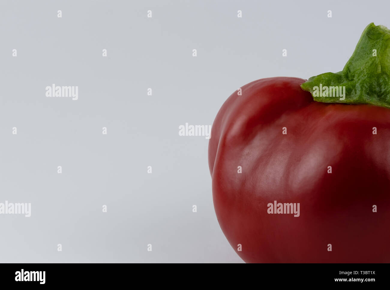 Closeup image of a red capsicum on a white background Stock Photo - Alamy