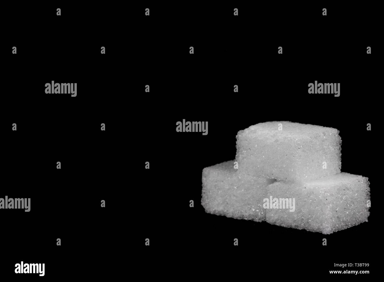 Pyramid of white sugar cubes isolated against a black background Stock ...