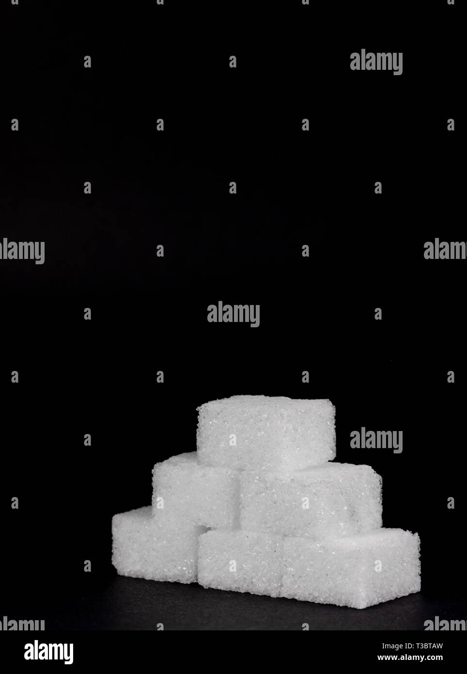 Pyramid of white sugar cubes isolated against a black background Stock ...