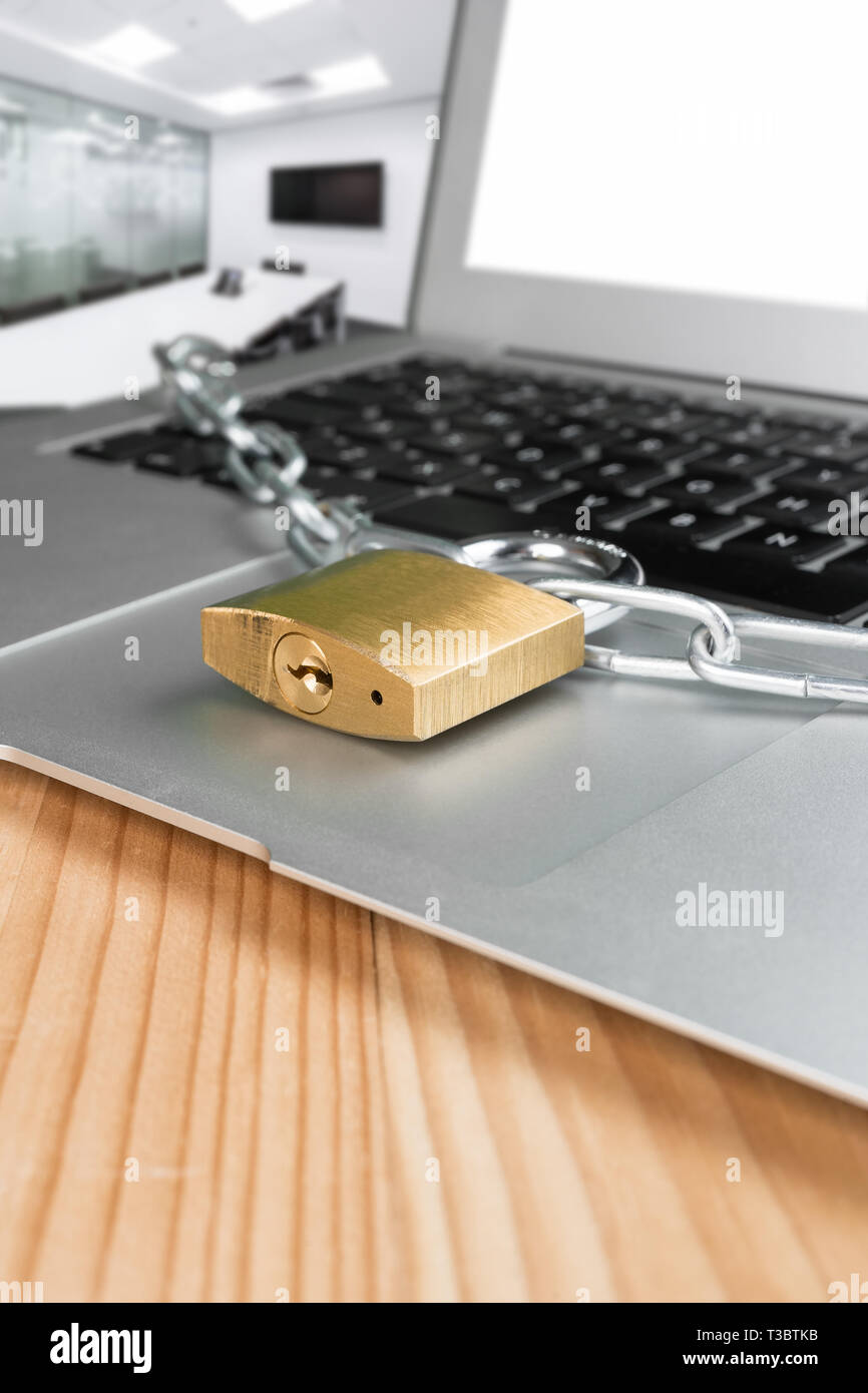 Padlock and chain with laptop computer in a presentation board office ...