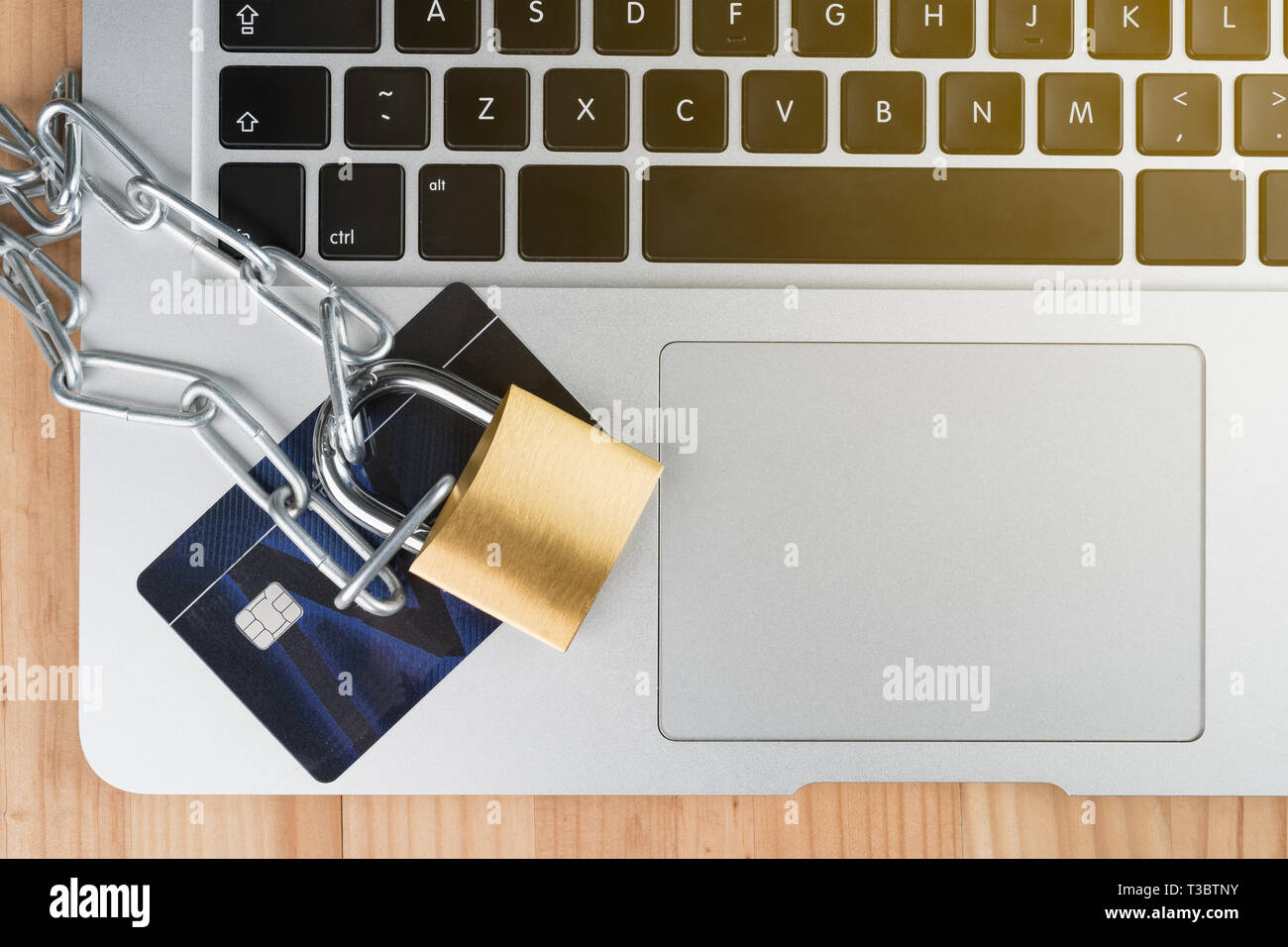 Padlock with chain and credit card on a laptop computer keyboard ...