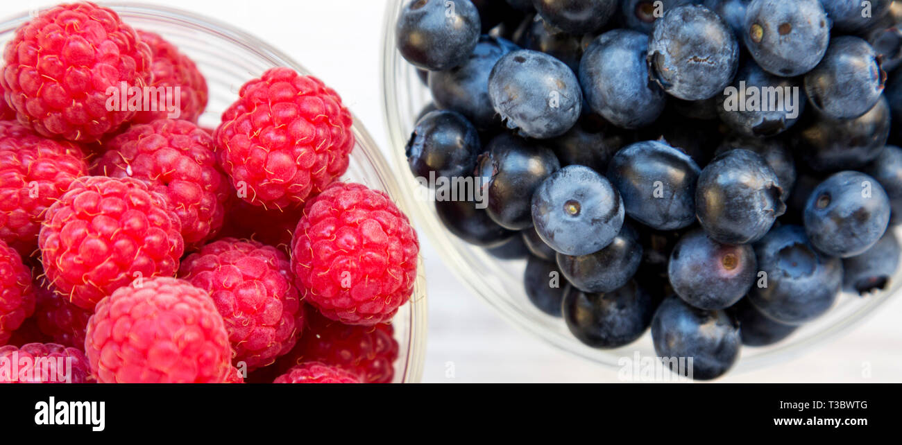 Full bowls of blueberries, and raspberries, top view. Healthy eating ...